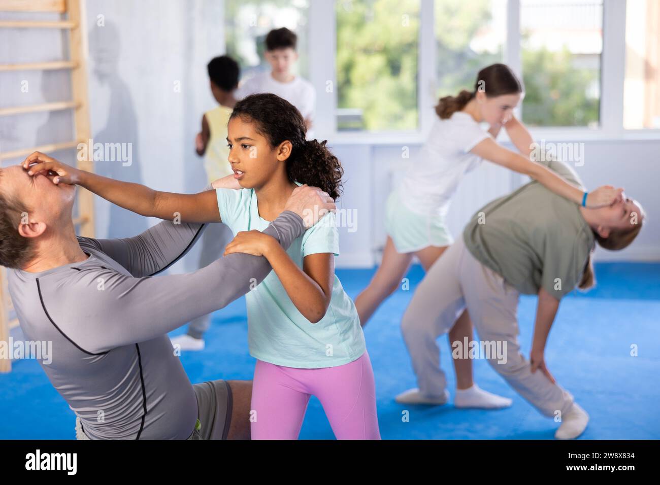 Coach and girl training self-defense techniques Stock Photo - Alamy