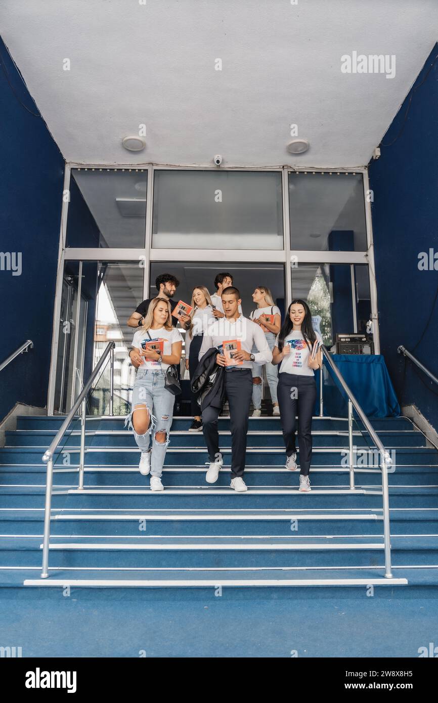 A diverse group of university students collaborating, discussing, and ...