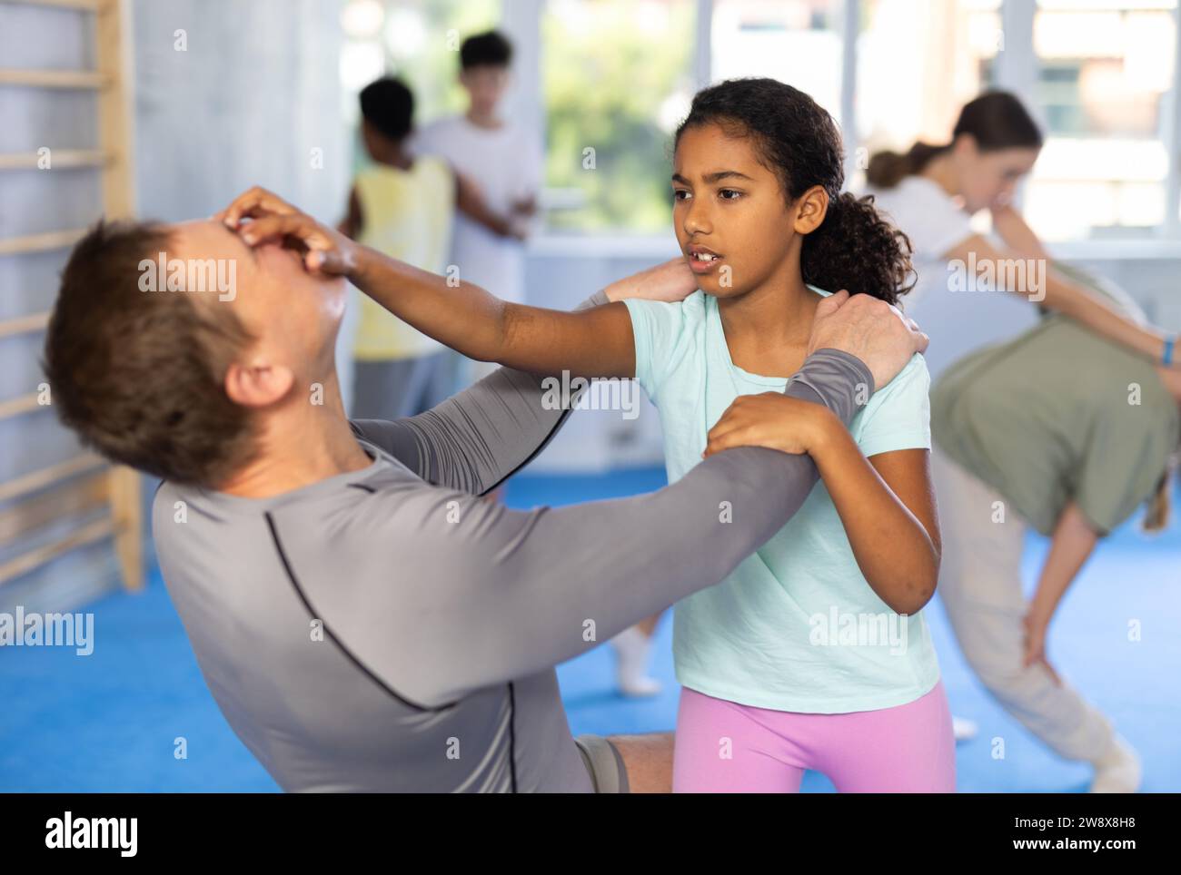 Coach and girl training self-defense techniques Stock Photo - Alamy