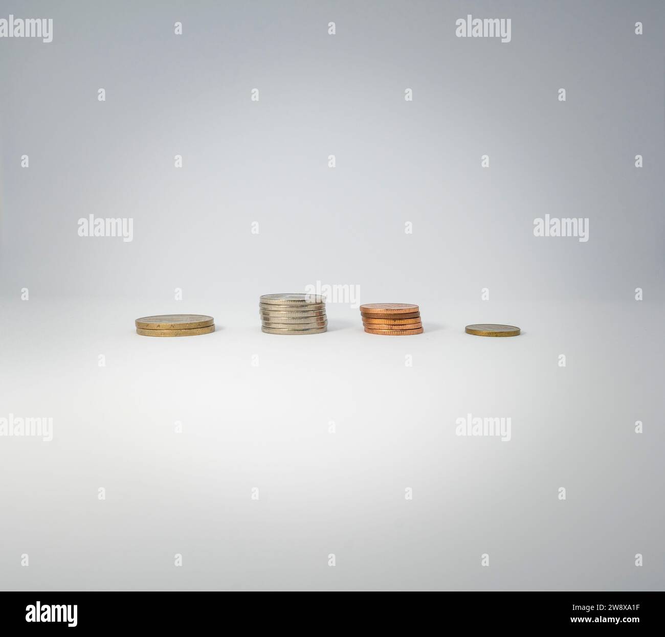 Coins stacked in columns by type Stock Photo - Alamy