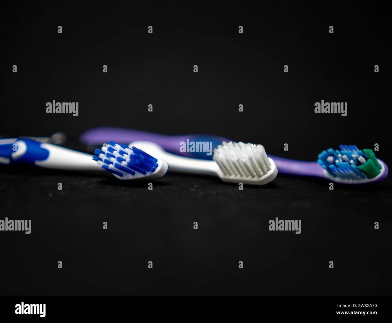 Three toothbrushes of different color Stock Photo - Alamy