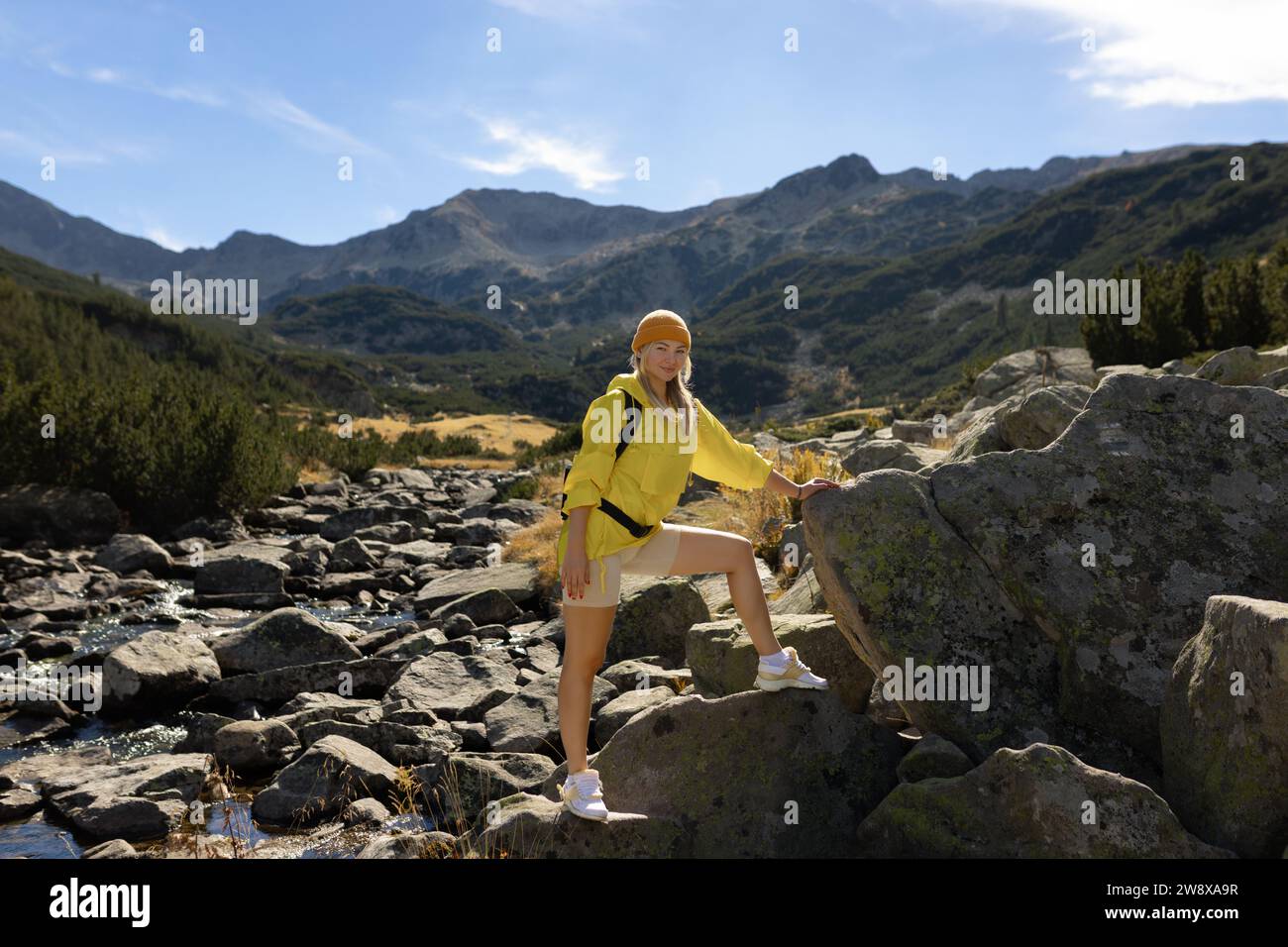 Excited woman walking through landscape outdoors. An active girl enjoys ...
