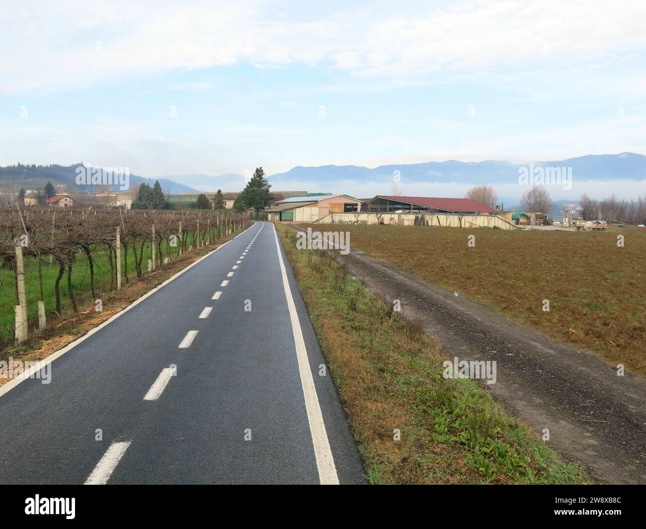 long newly asphalted cycle path in the middle of the plain without ...