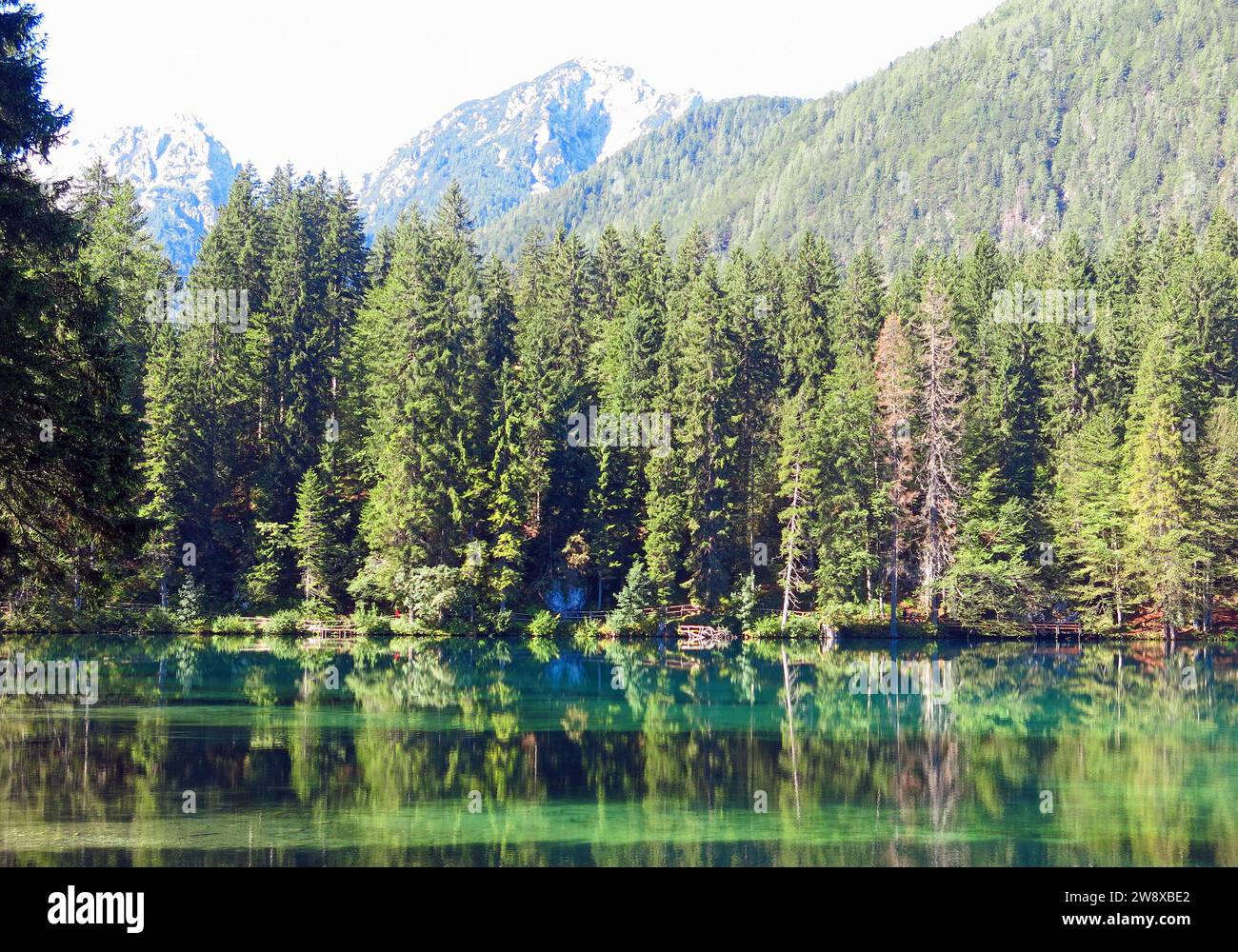 alpine landscape with crystal-clear water lakes and the reflection of ...