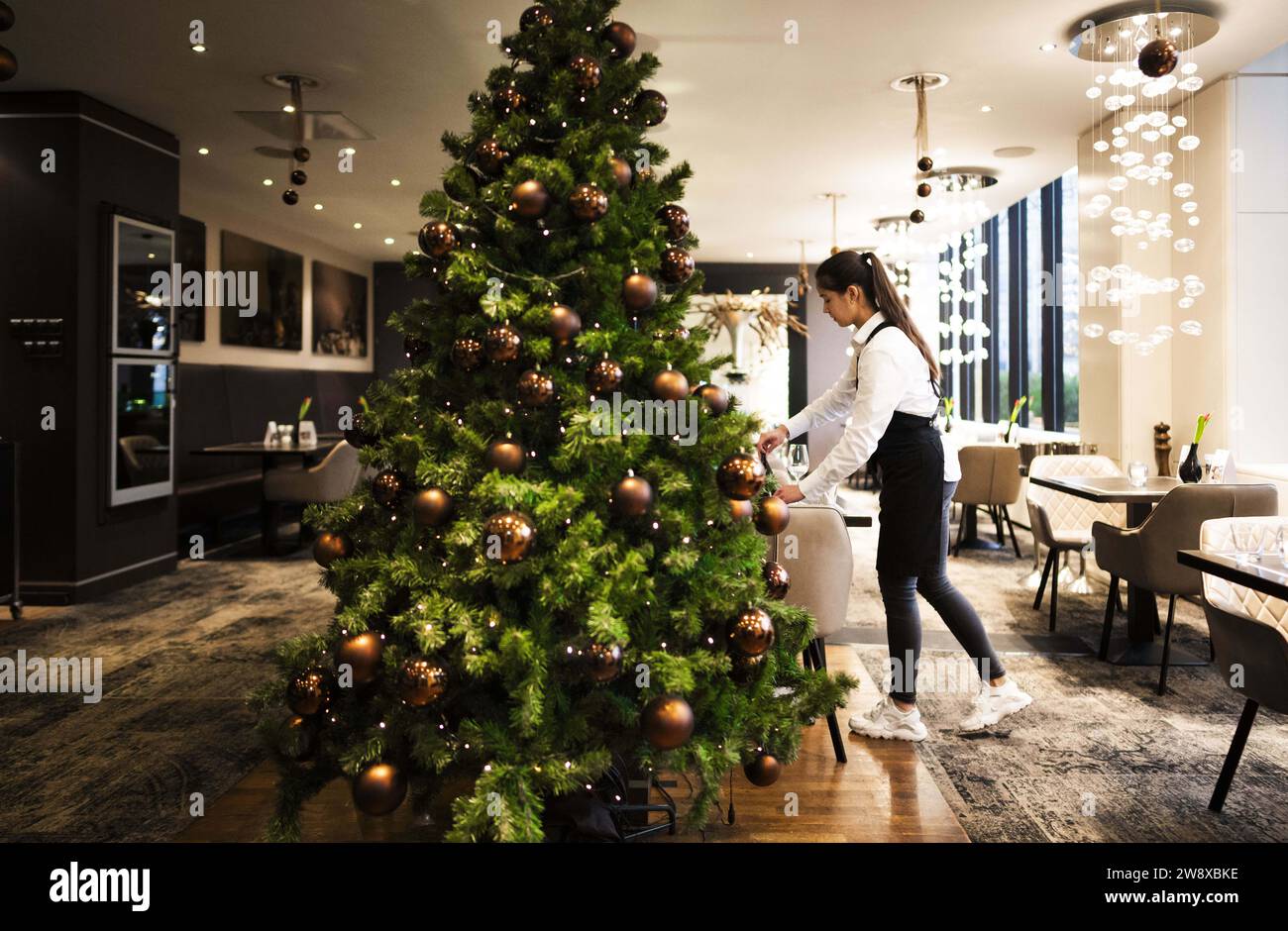 ILLUSTRATION - A table is being set for Christmas dinner in a ...