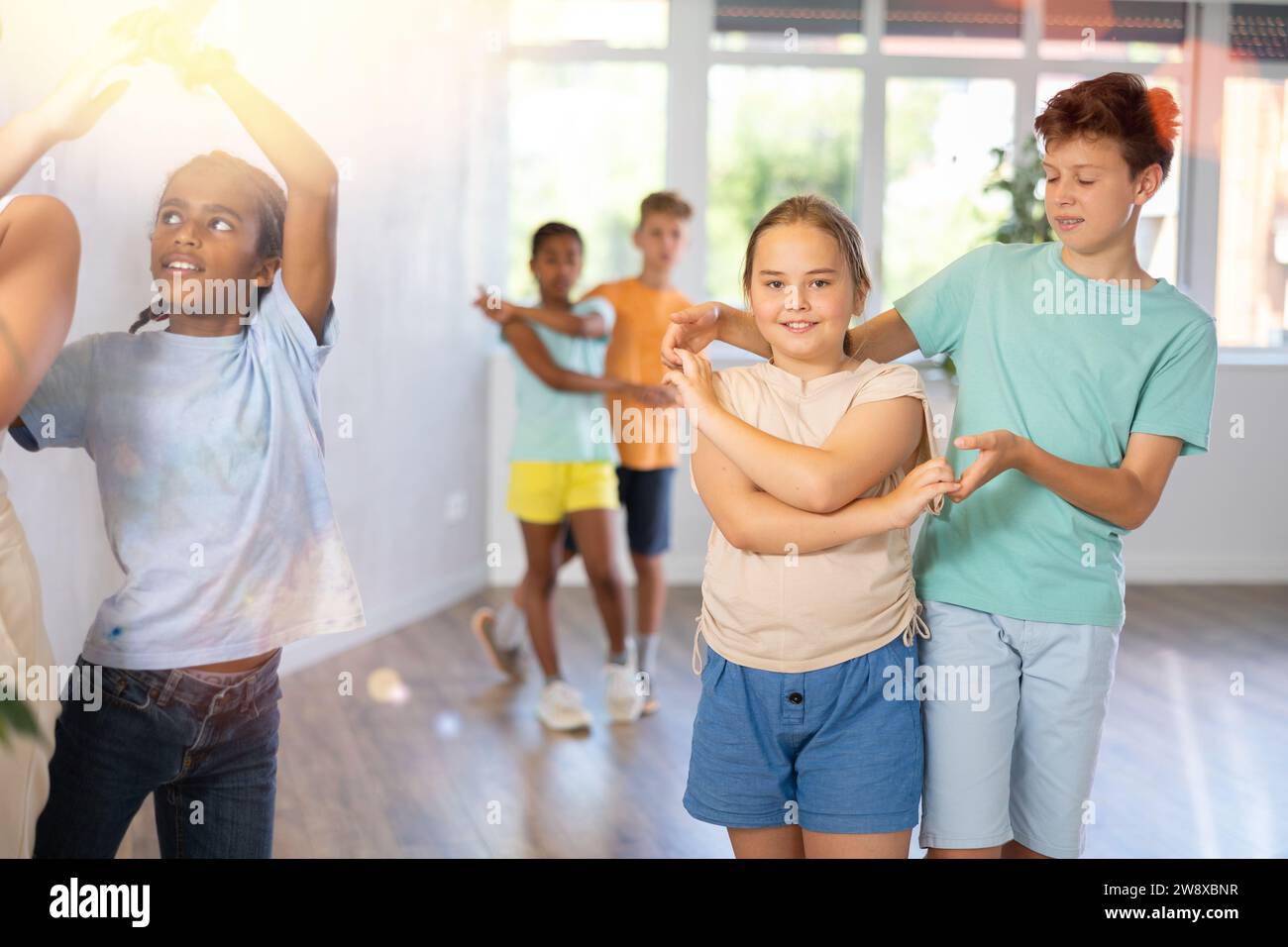 Light-skinned boy and girl dance in pairs and rehearse dance before ...