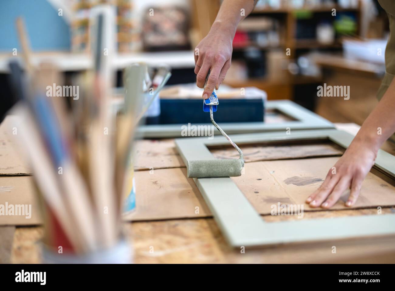 Carpenter painting furniture in her workshop, close-up Stock Photo - Alamy