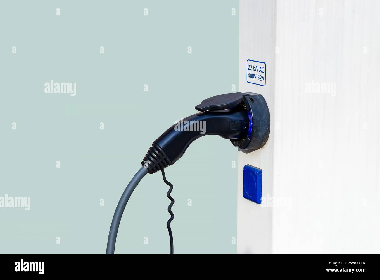 Closeup of charger plug to an electric vehicle from charging station ...