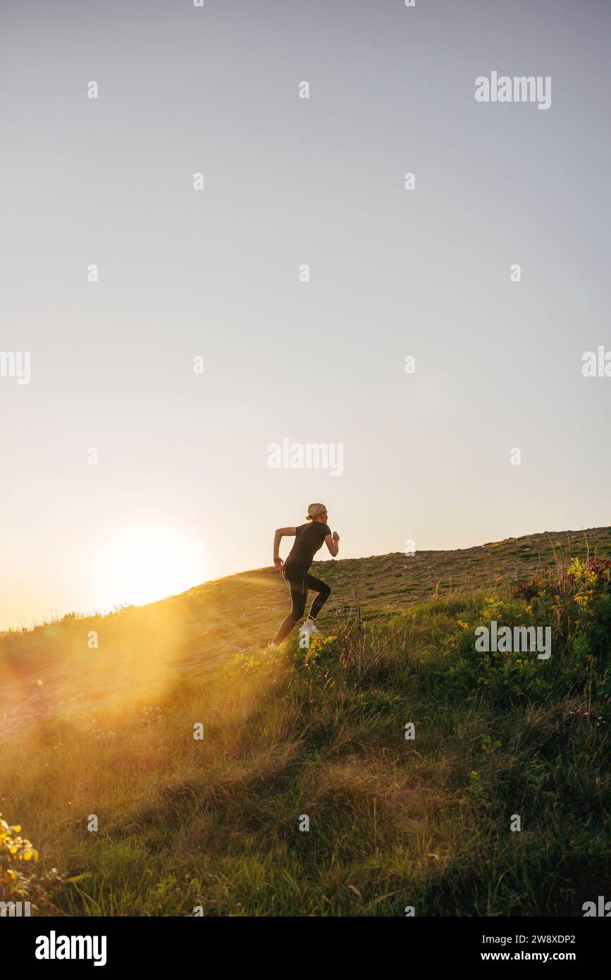 Woman running hill hi-res stock photography and images - Alamy