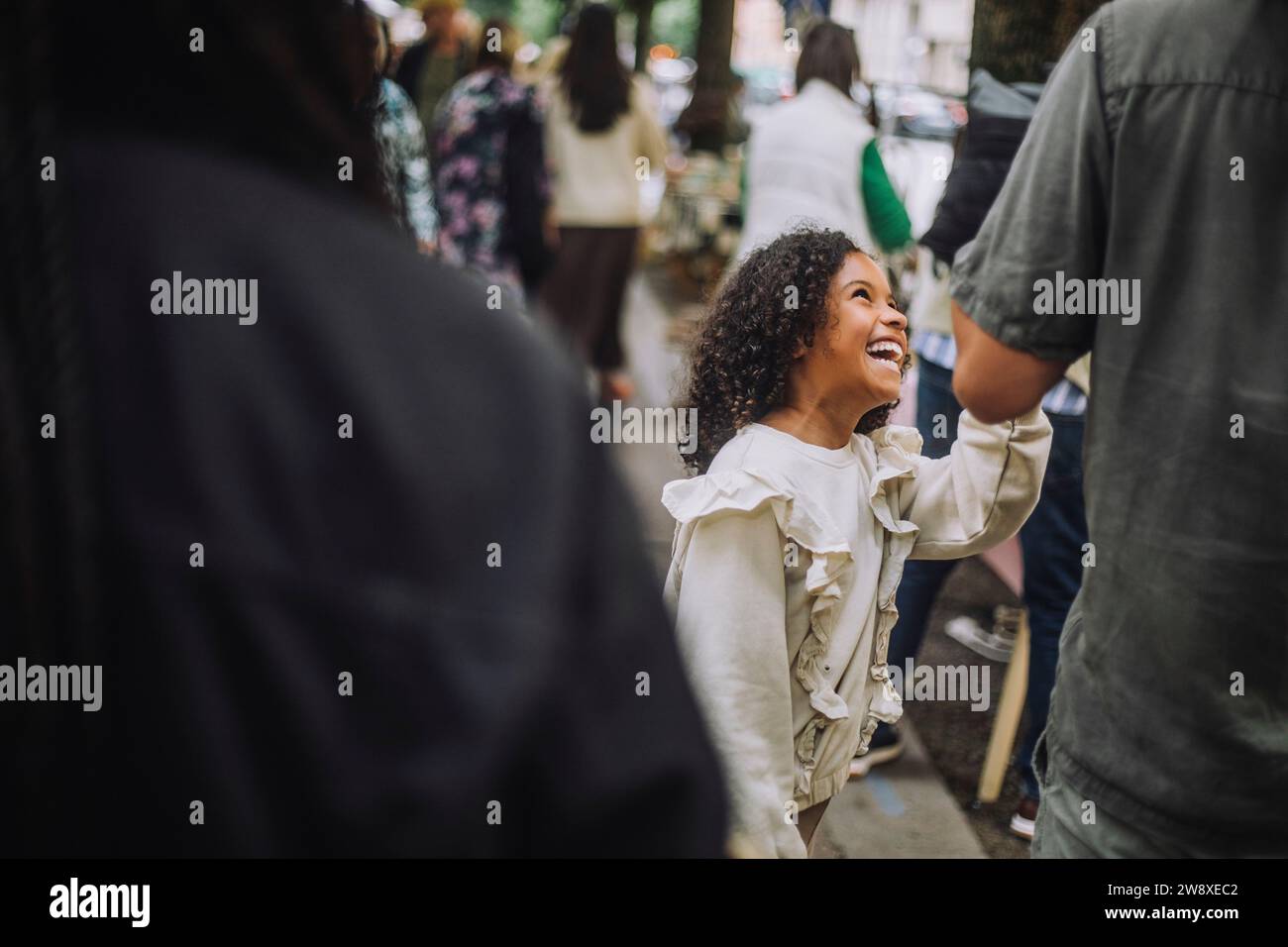 Cheerful daughter having fun with father at flea market Stock Photo - Alamy