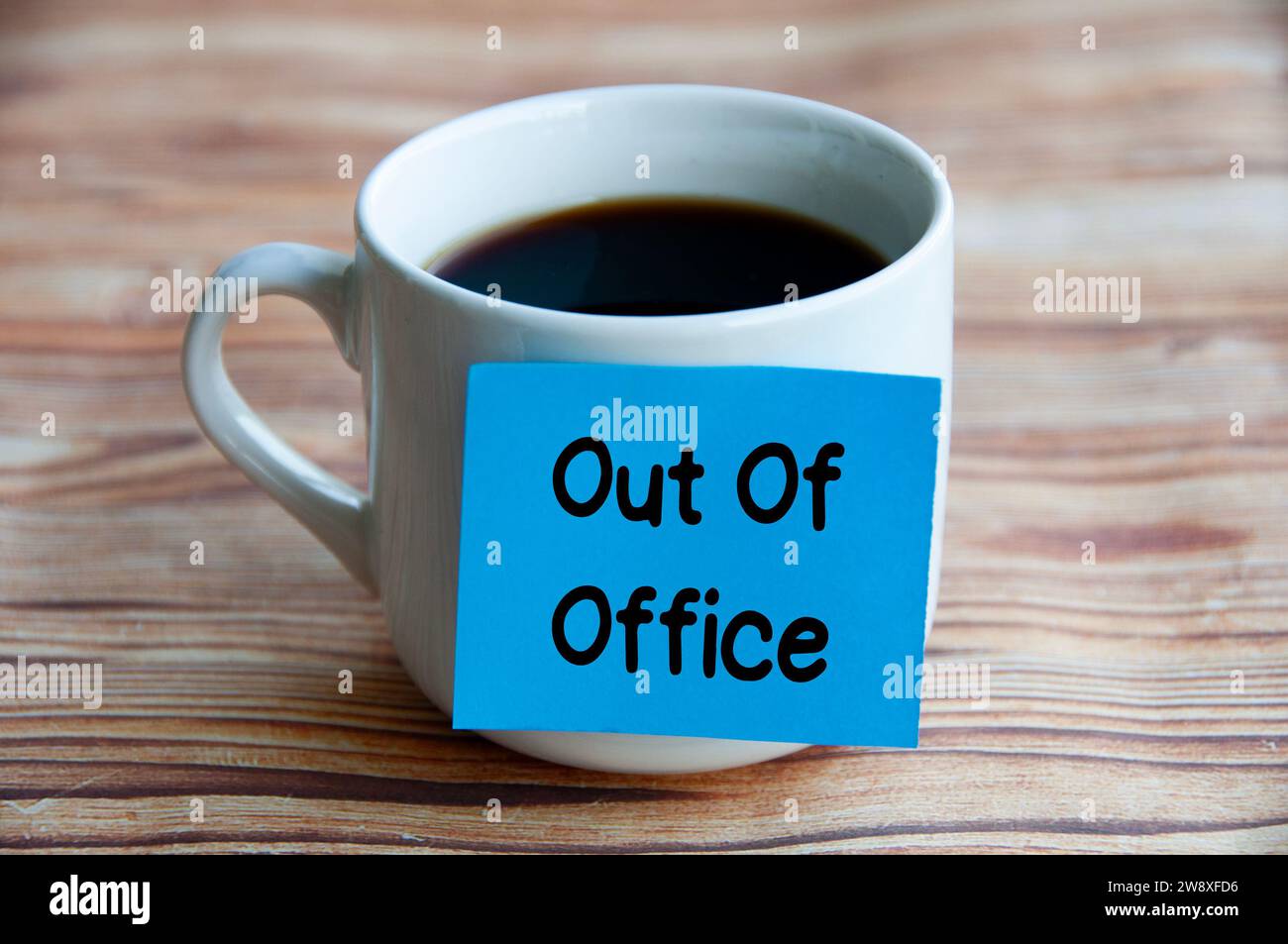 Out of office text on blue sticky note with coffee cup background Stock ...