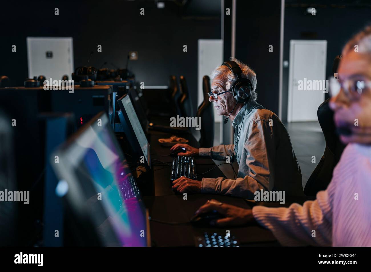 Female and male friends spending leisure time while playing video game ...