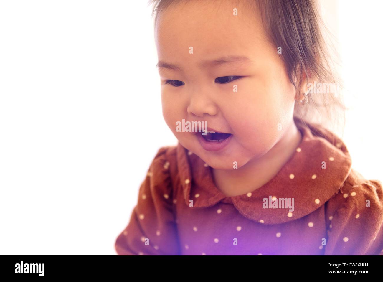 Close-up of a child portrait of a cute little Asian girl. Sweet ...