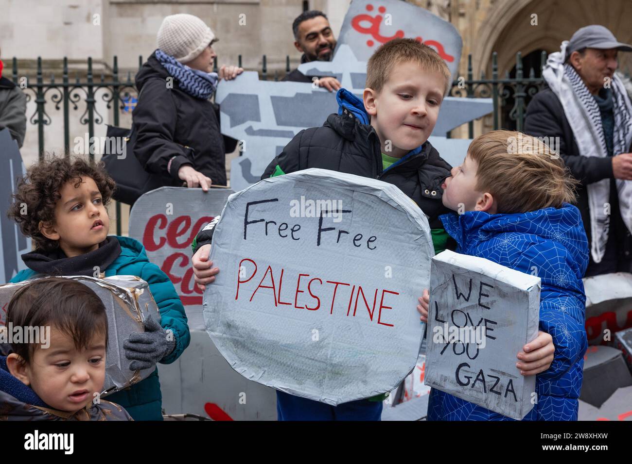 London, UK. 22nd December, 2023. Children hold handmade rubble during a ...