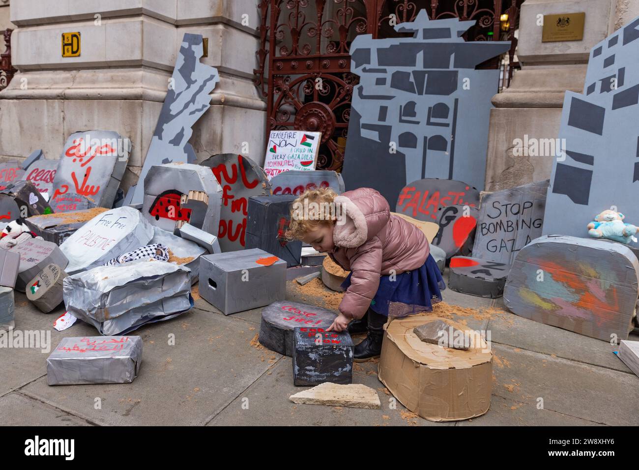 London, UK. 22nd December, 2023. A child plays among handmade rubble ...