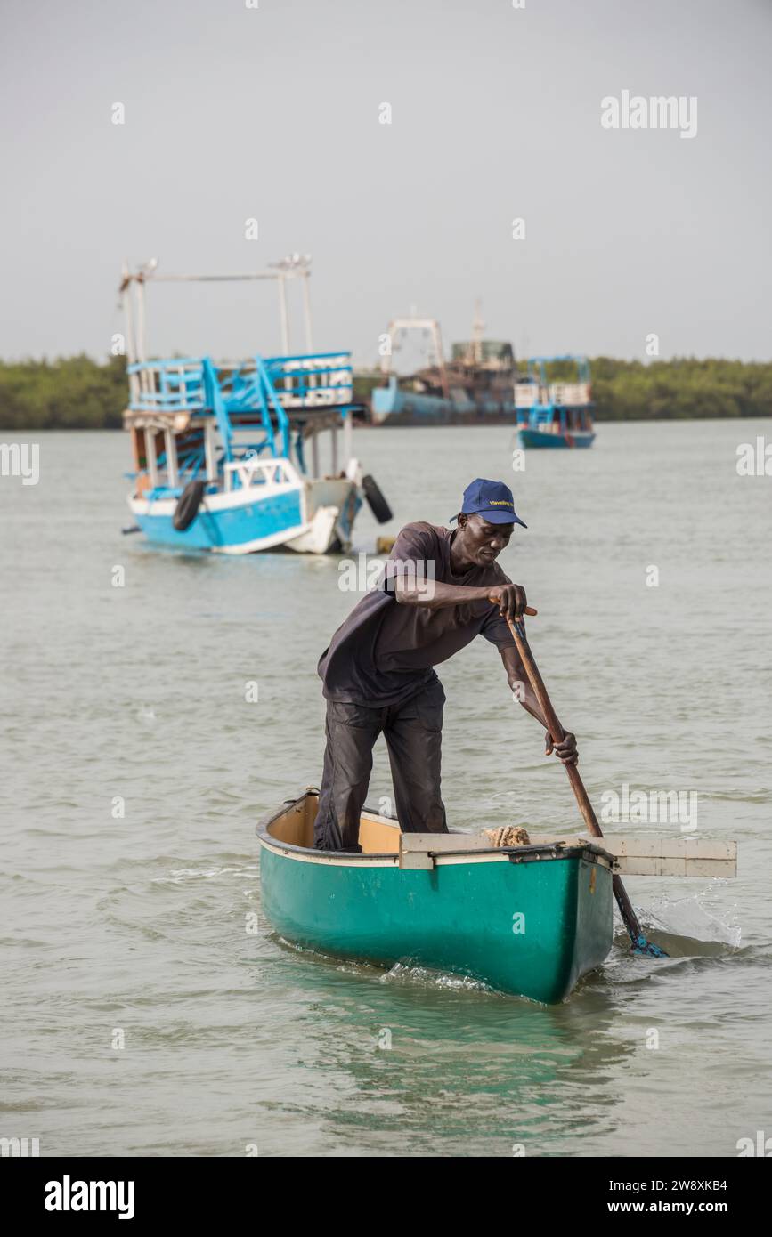 Sailor in a small boat in a port in Banjul, Gambia Stock Photo - Alamy