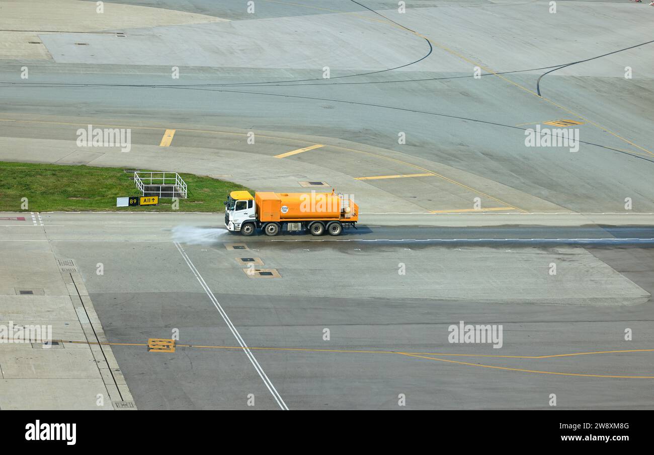 Cleaning truck operation on taxi way at the international airport Stock ...