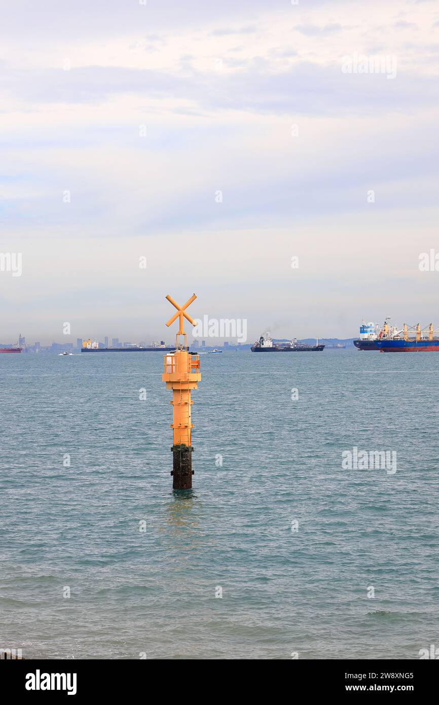 Marine navigation signal pole in the blue sea, Yellow coastal ...