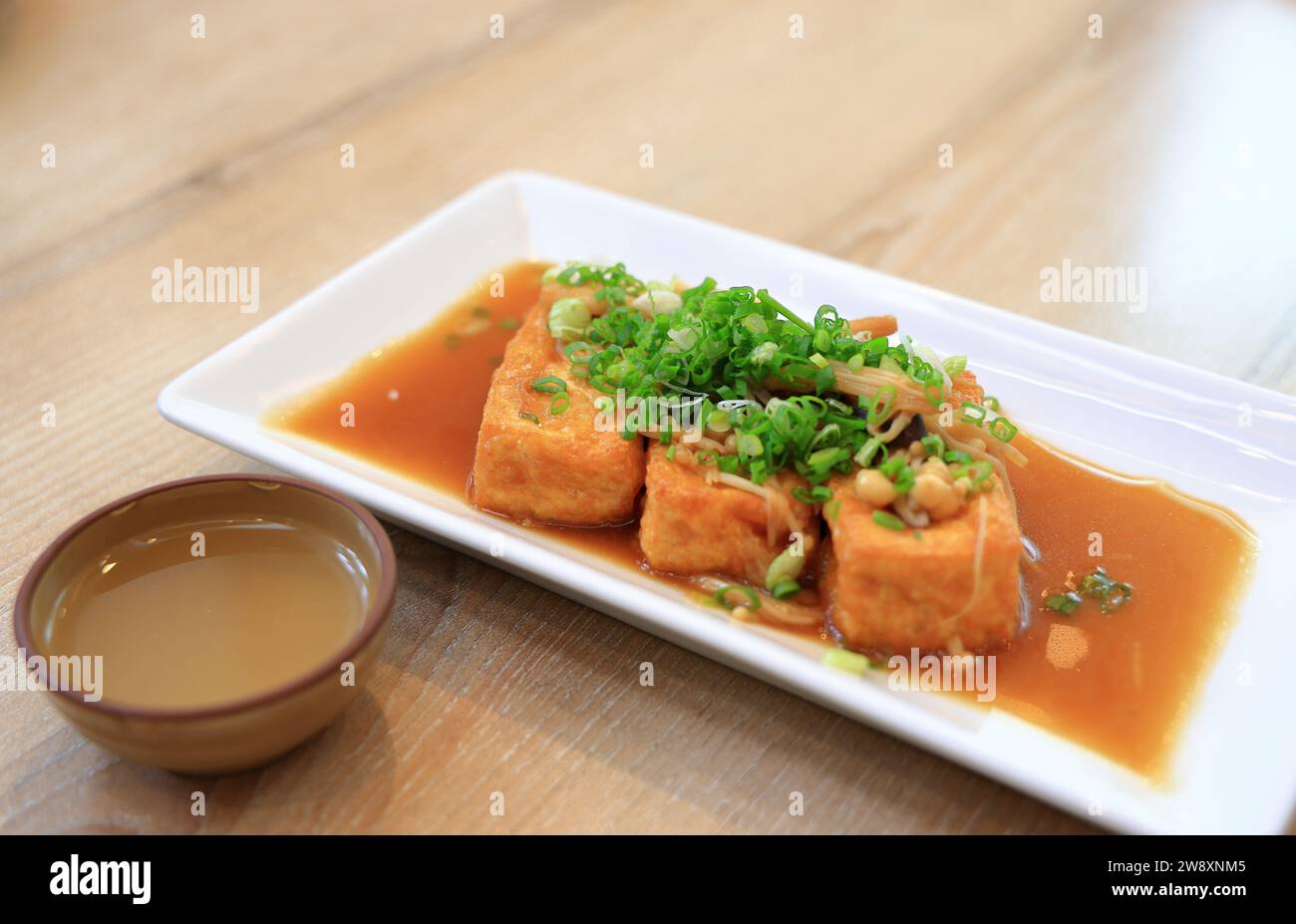 Japanese fusion food tofu steak Serving on white plate Stock Photo - Alamy
