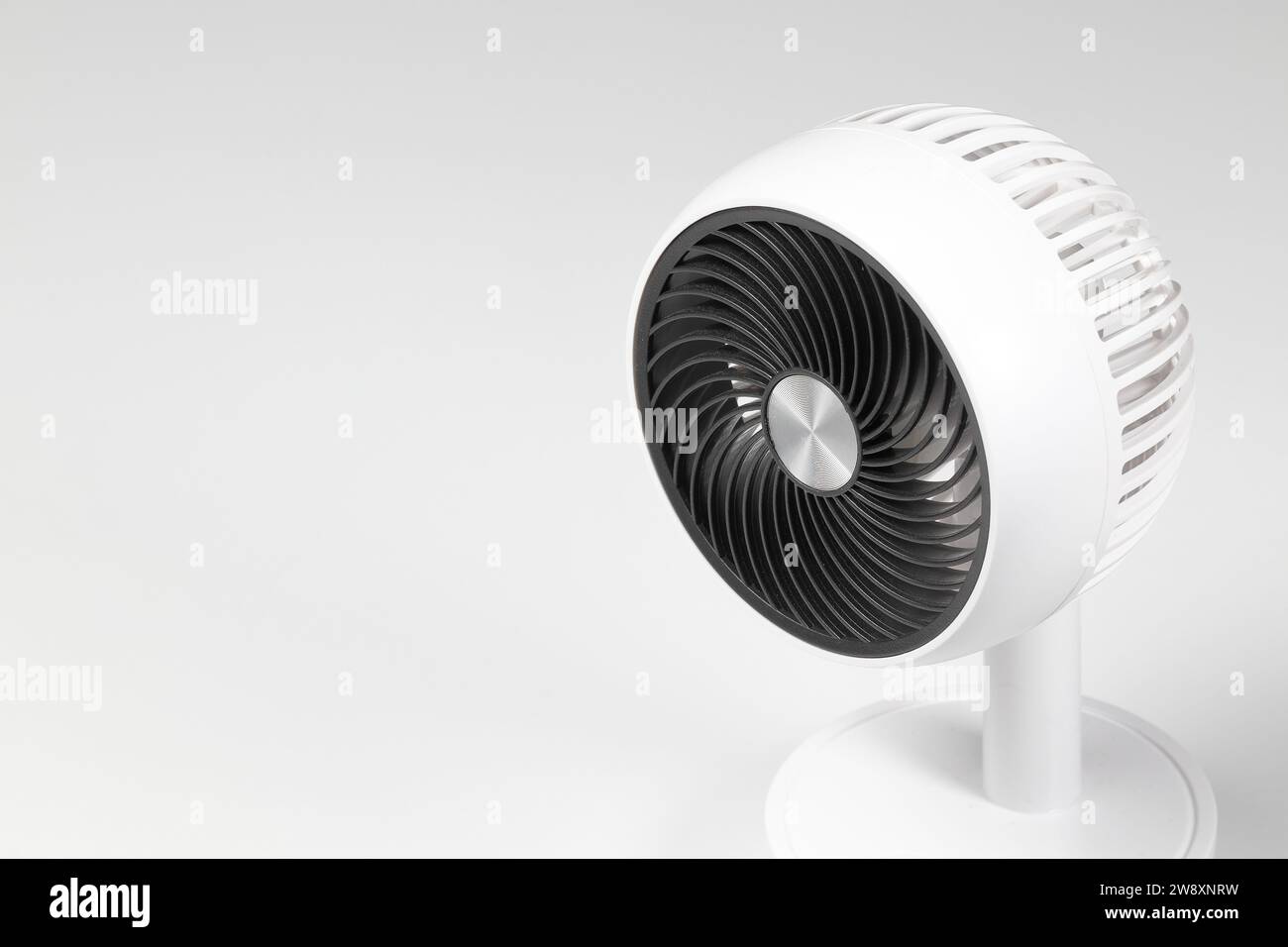 Small white plastic desktop fan side view, isolated on white background ...