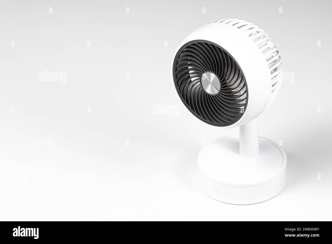 Small white plastic desktop fan side view, isolated on white background ...