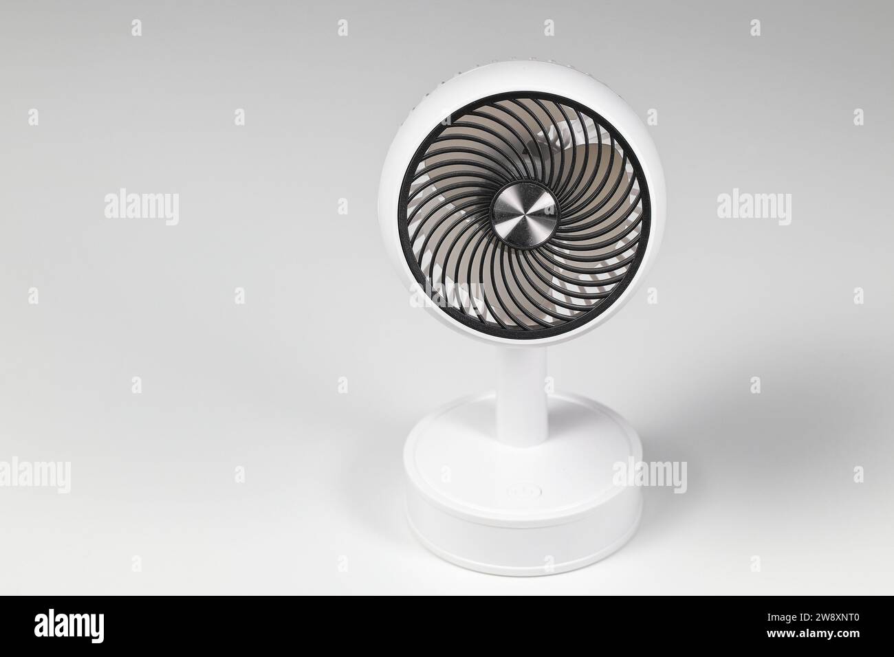 Small white plastic desktop fan side view, isolated on white background ...