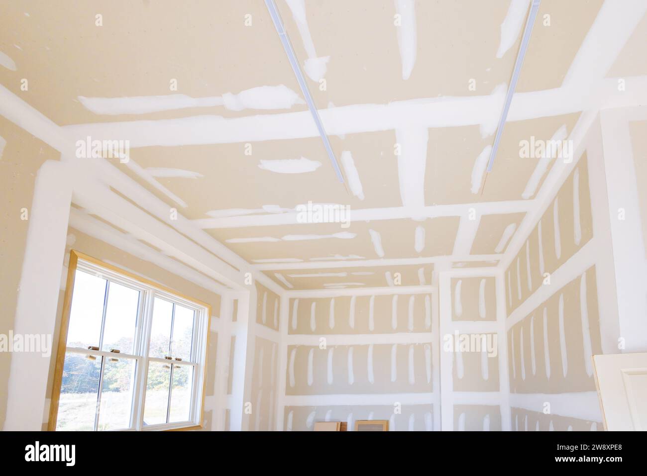 Finishing plastering drywall in ready to paint with new house under ...