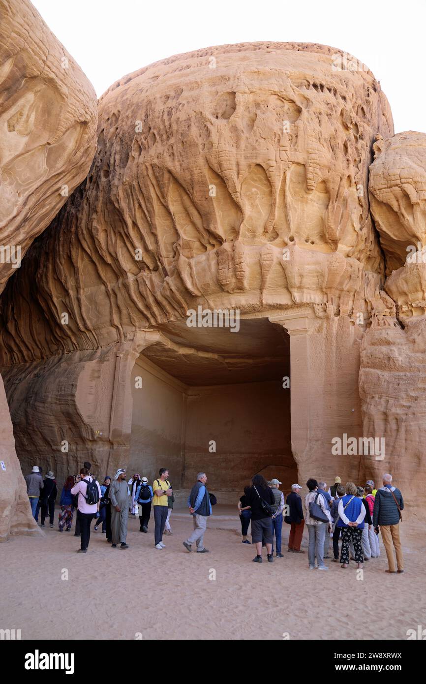 European tour group visiting The Diwan at Hegra on a trip around AlUla ...