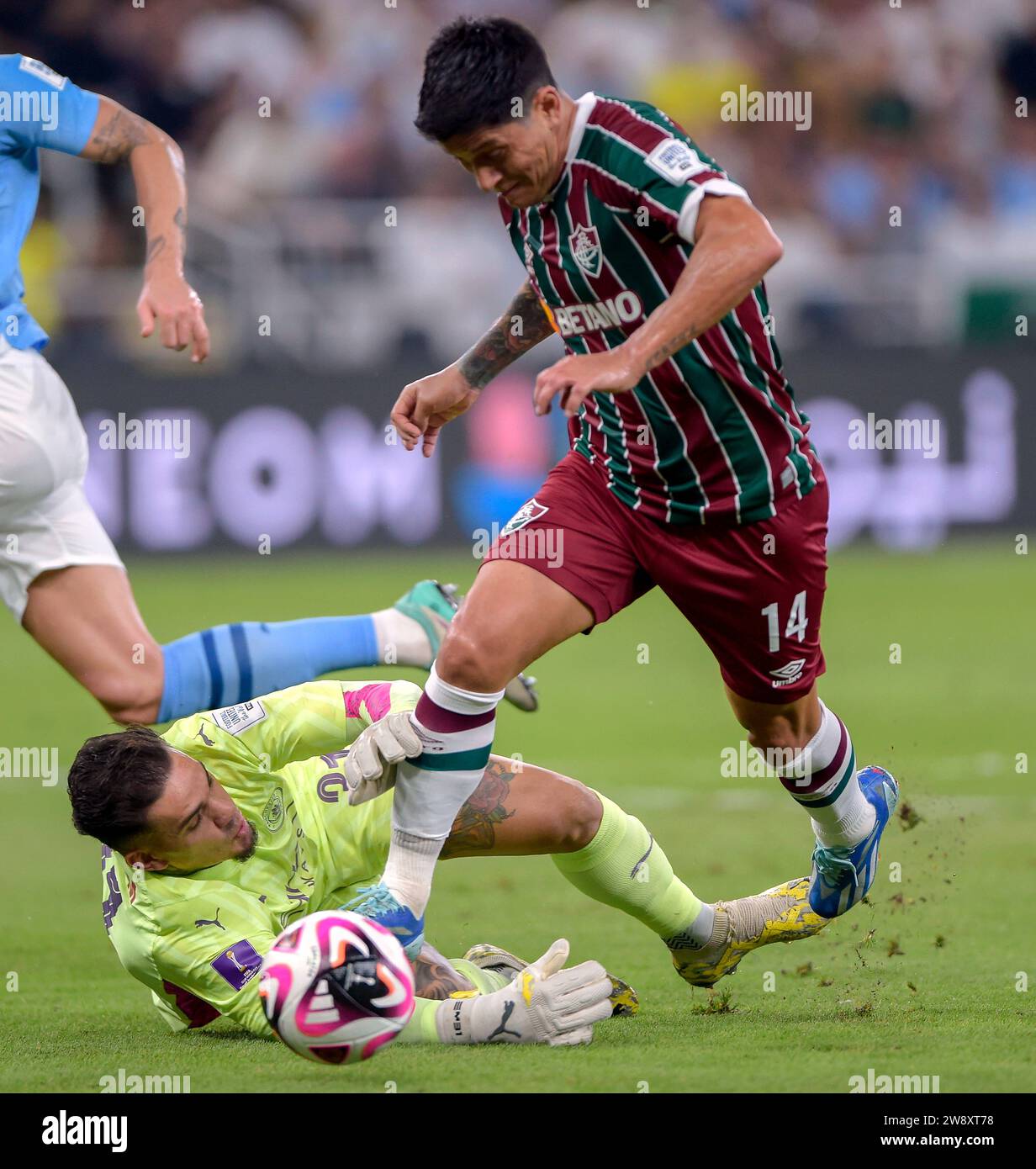 Manchester City goalkeeper Ederson dives at the feet of Fluminense's ...