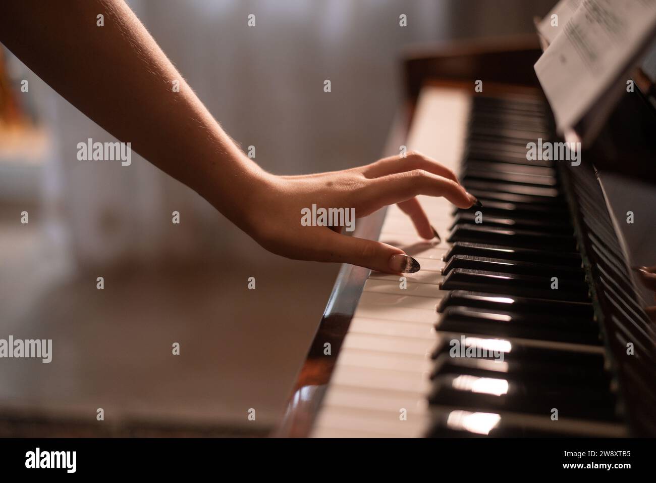 a pianist's hand is on the piano keys Stock Photo - Alamy