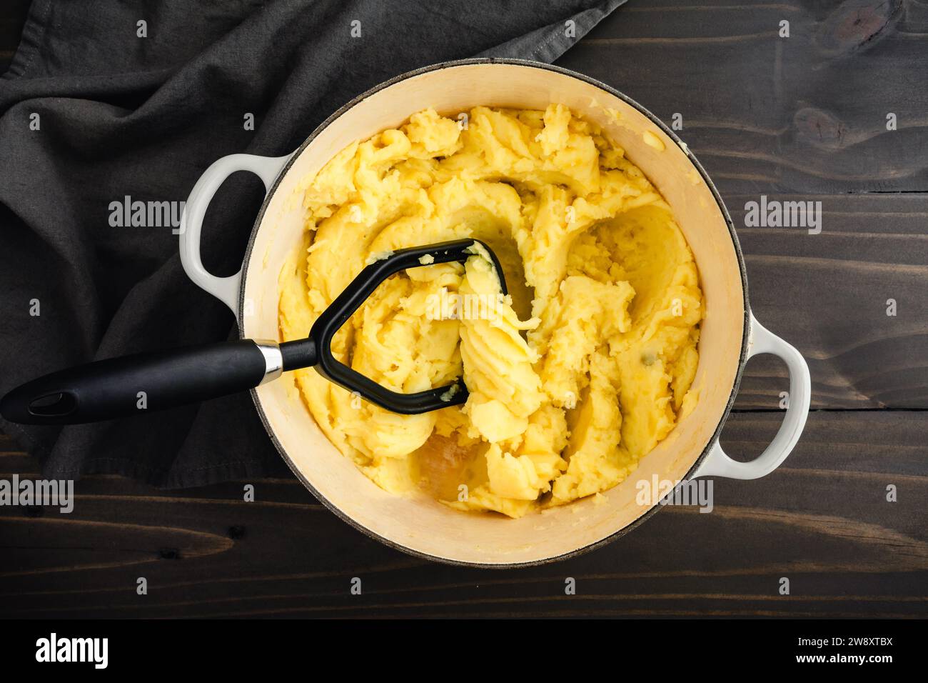 Mashing Boiled Yukon Gold Potatoes in a Large Pot: Potato masher and ...