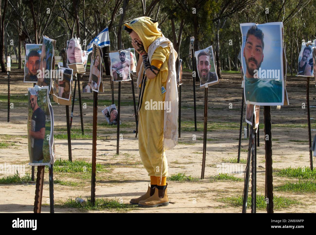 Yonatan Hinon, 30, from Jerusalem, prays and mourns at a photo of one ...