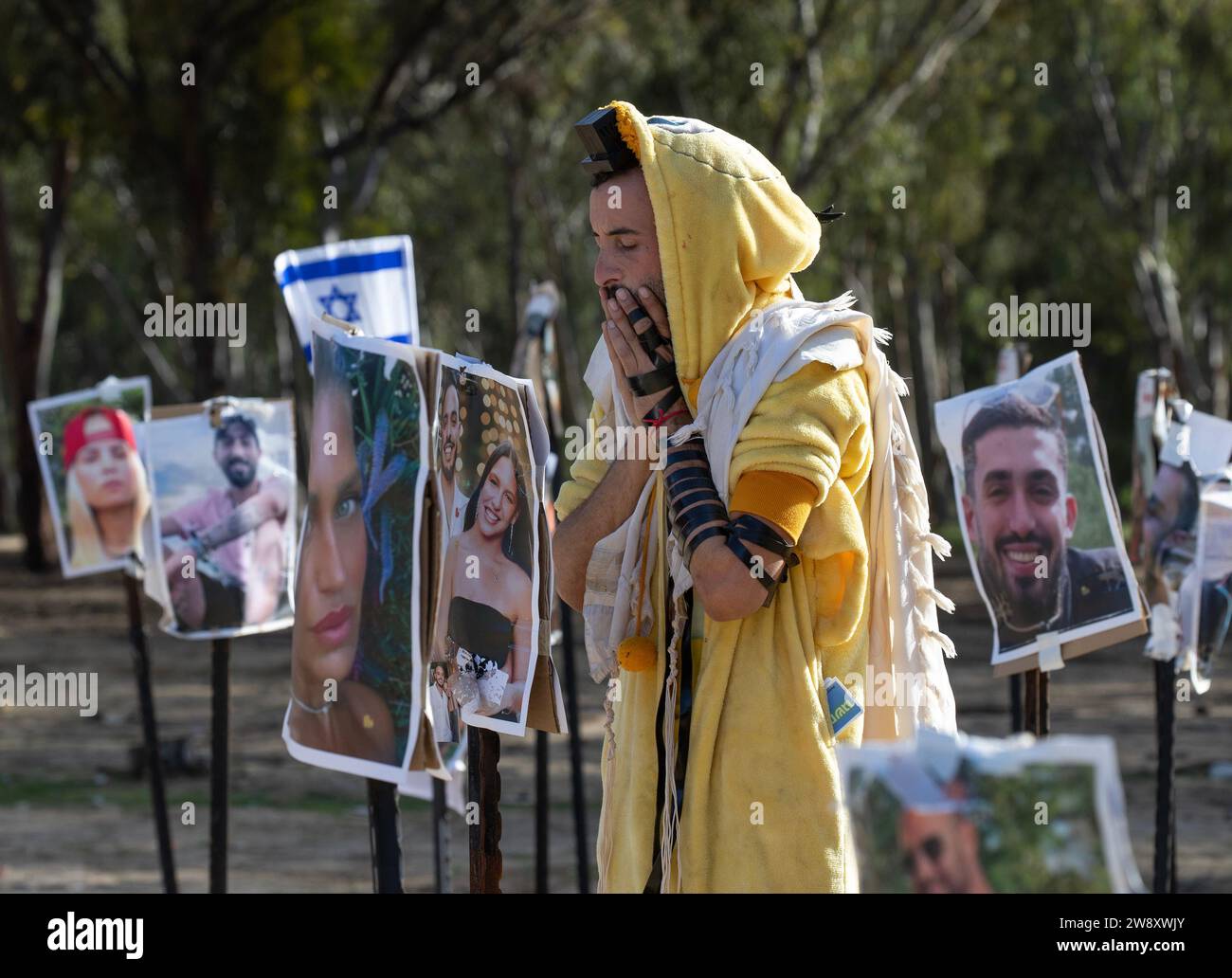 Yonatan Hinon, 30, from Jerusalem, prays and mourns at a photo of one ...