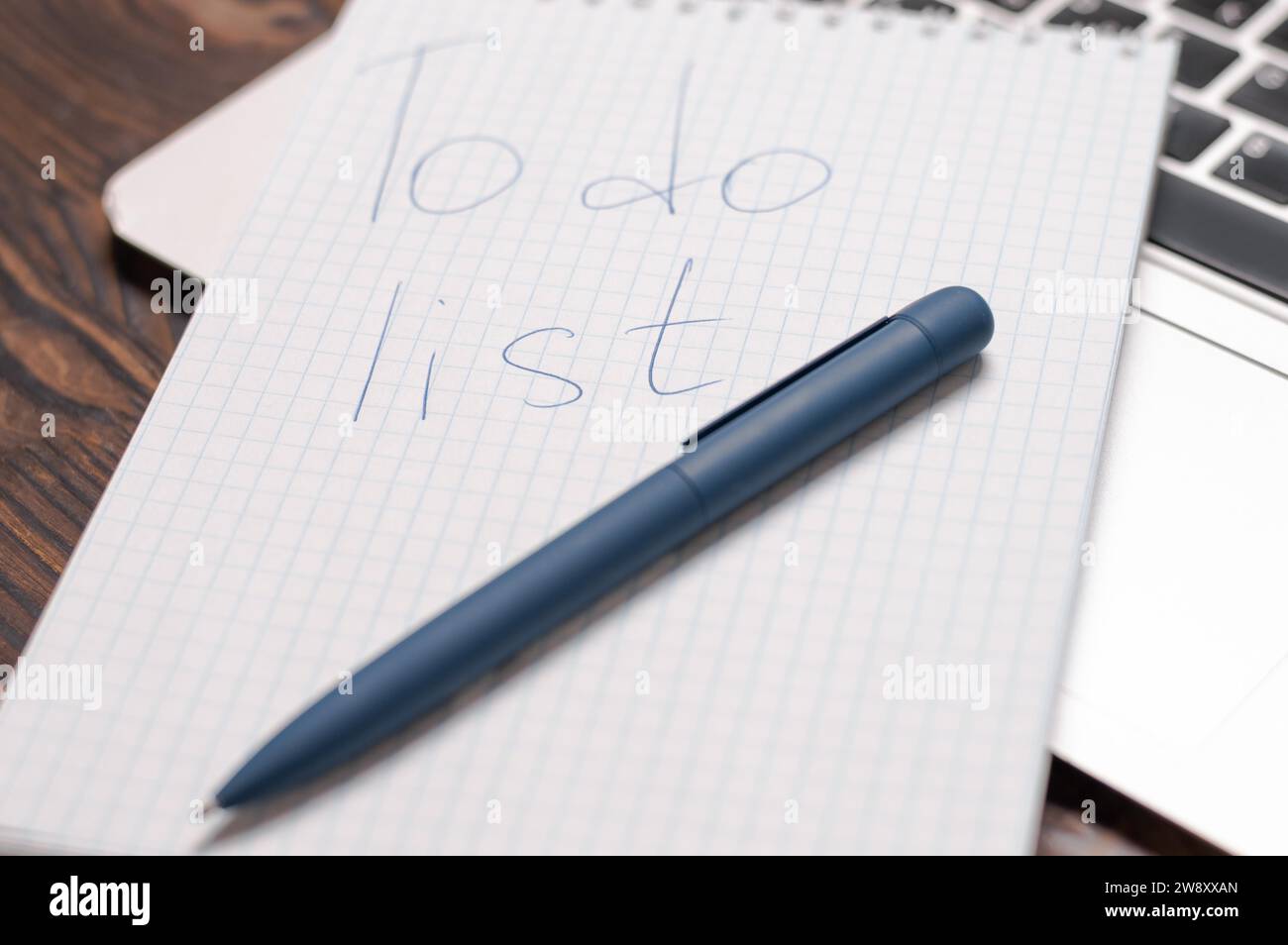 Image of a notebook with a pen lying on a laptop. Business planning ...