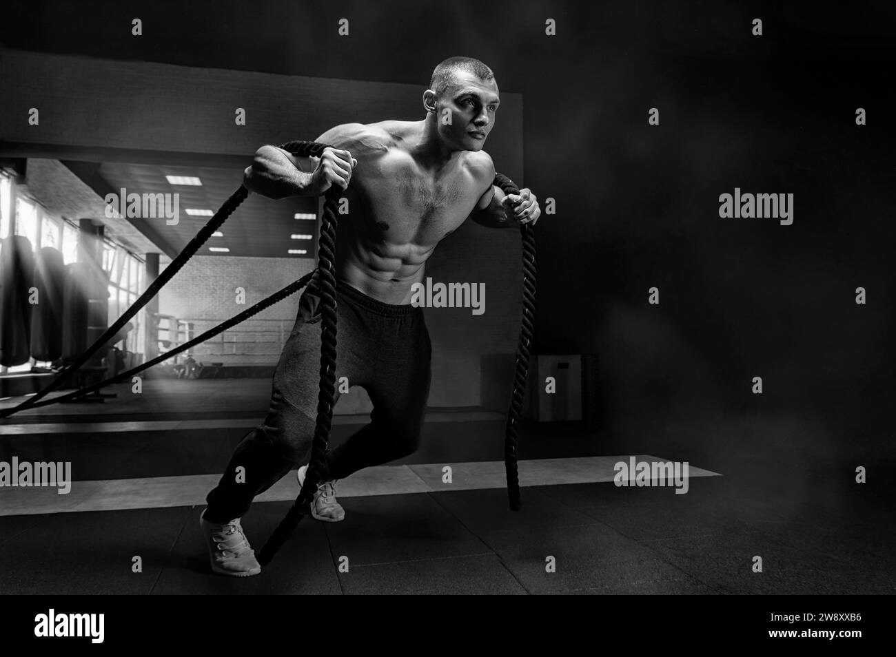 Portrait of an athlete who pulls the ropes. View from below. The ...