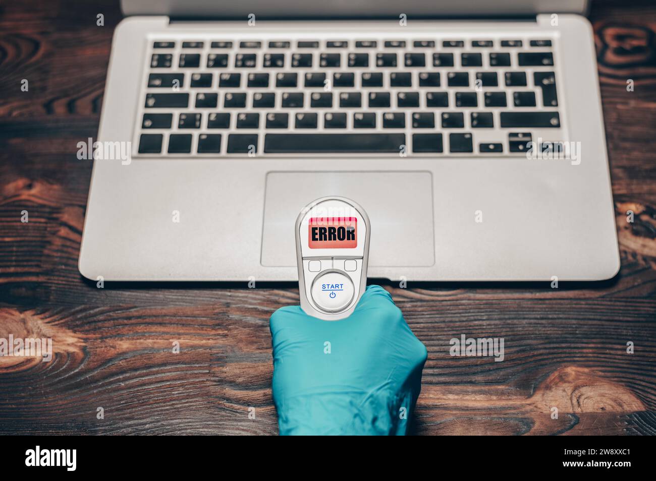 The technician applies an infrared thermometer to the laptop panel ...