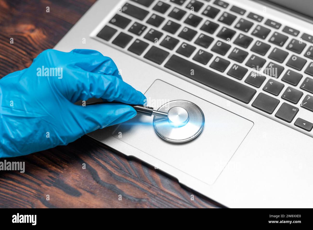 Image of hands in medical gloves. The technician applies a stethoscope ...