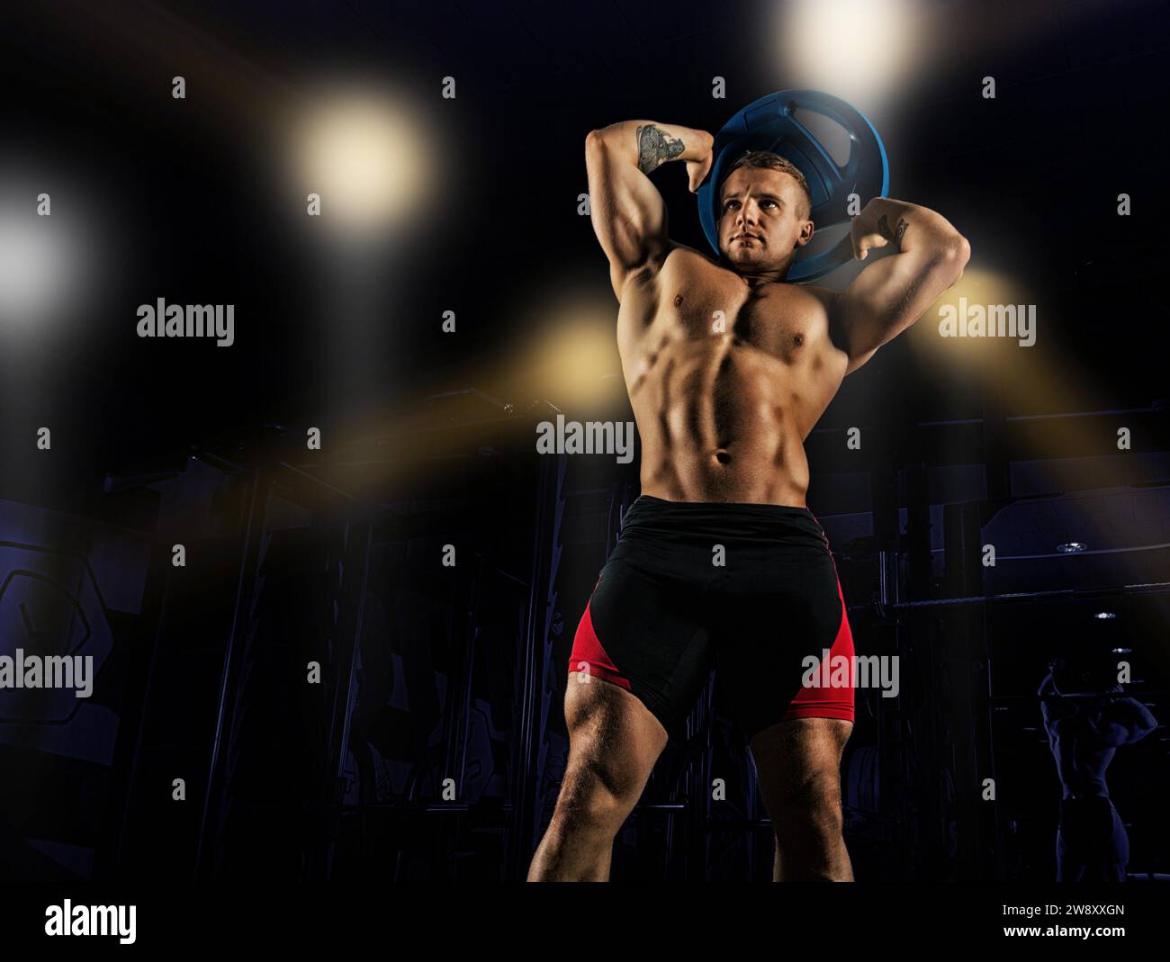 The weightlifter does the workout with burdening. He lifted a heavy ...