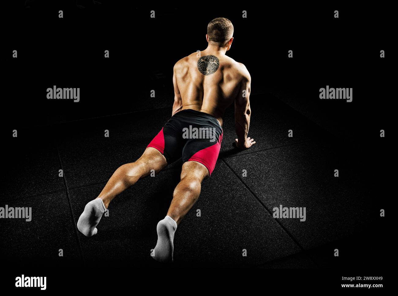 The athlete is stretched on a special cover in the gym. View from above ...