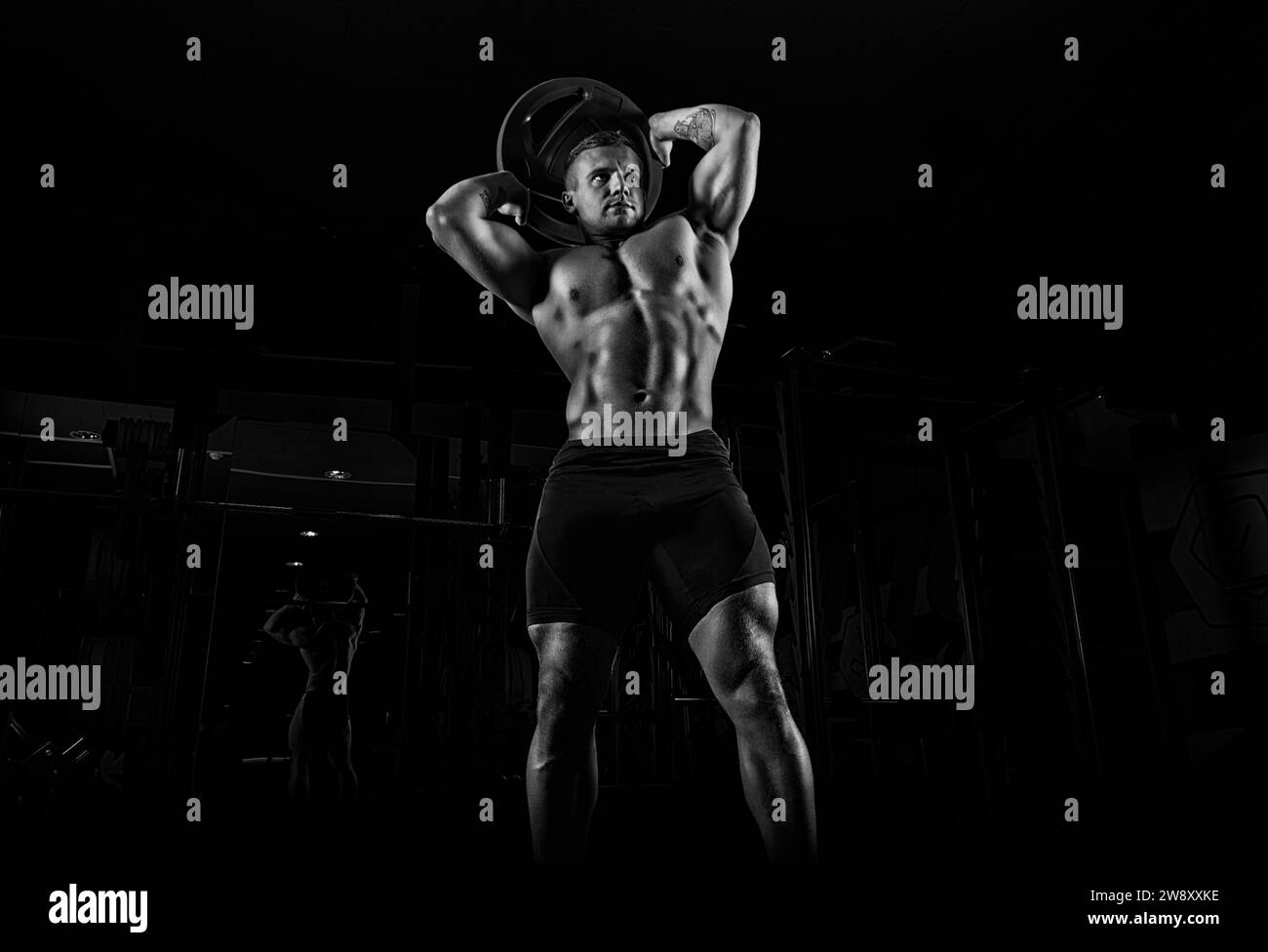 The weightlifter does the workout with burdening. He lifted a heavy ...