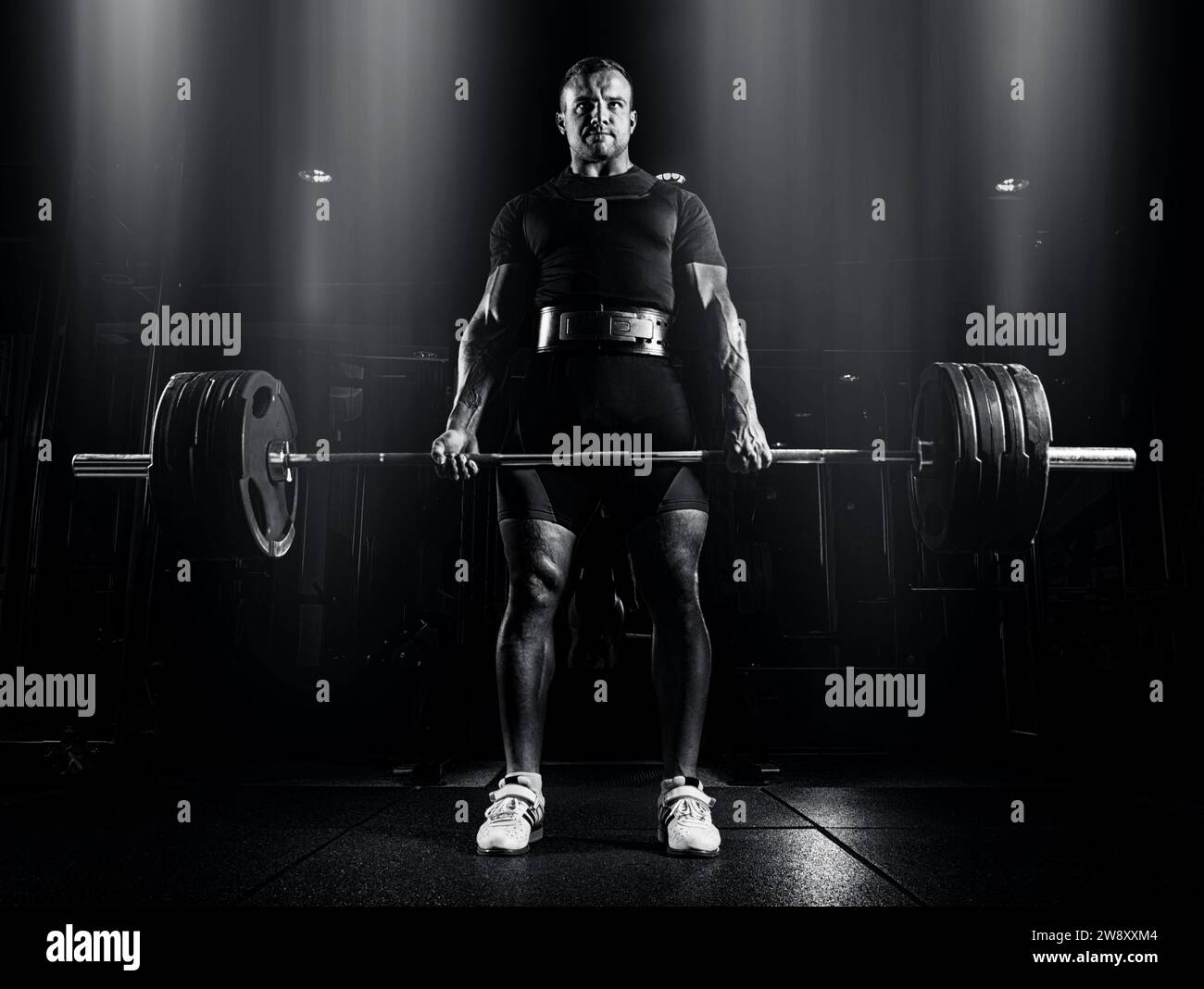 Professional athlete is standing and is holding a very heavy barbell ...