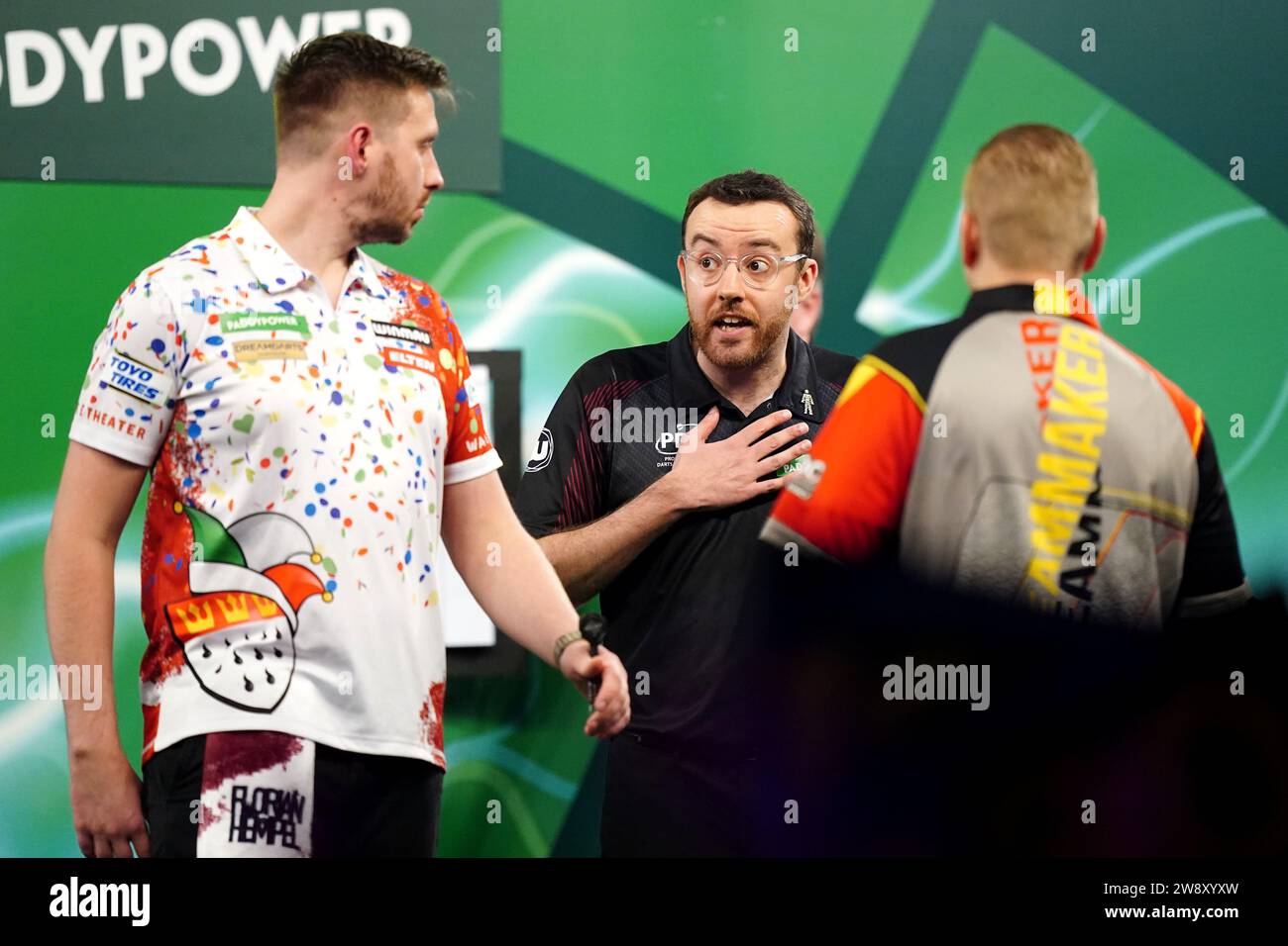 Referee Kirk Bevins (middle) speaks to Dimitri Van den Bergh and ...
