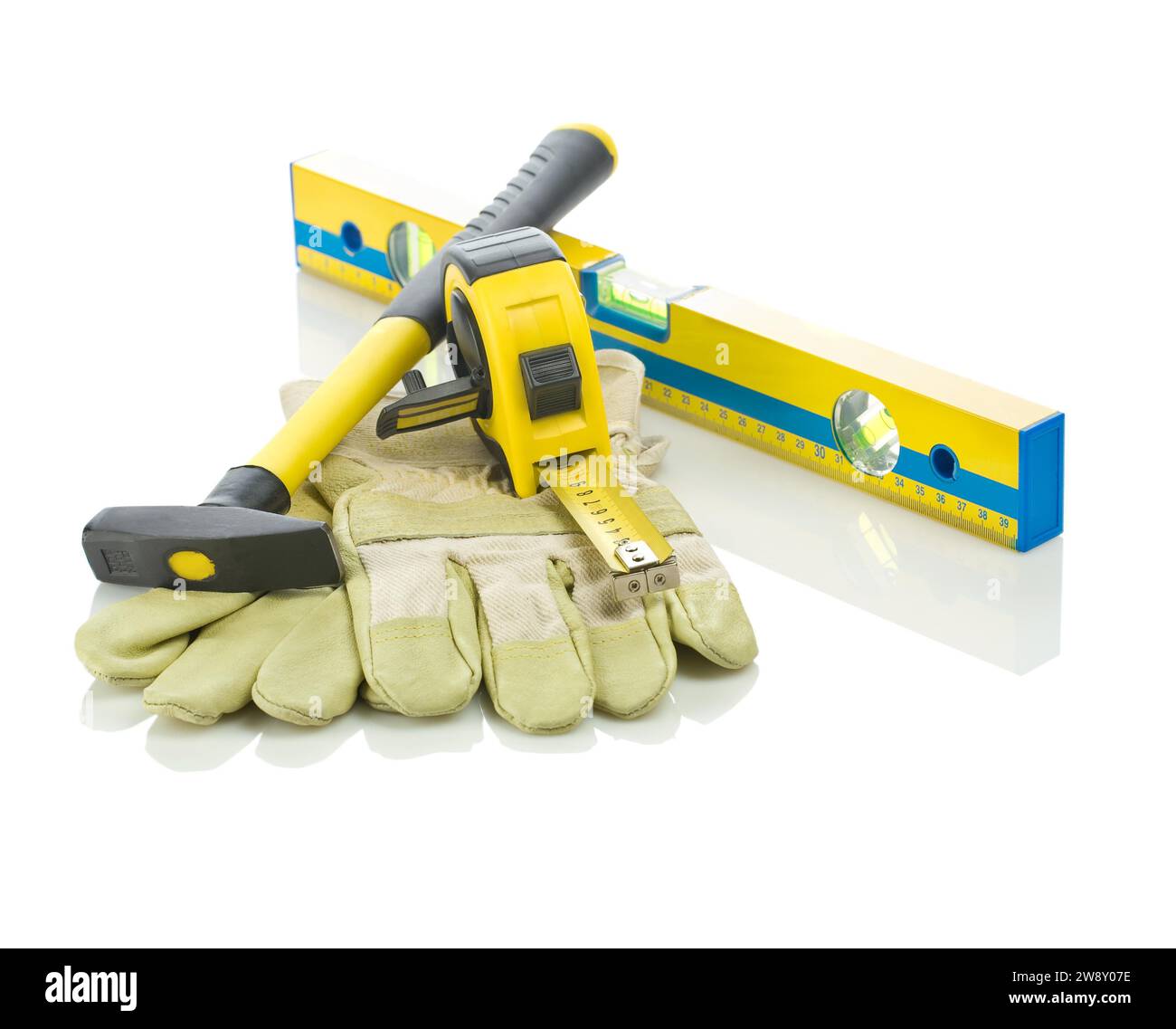 Spirit level, tape measure, hammer and gloves Stock Photo - Alamy