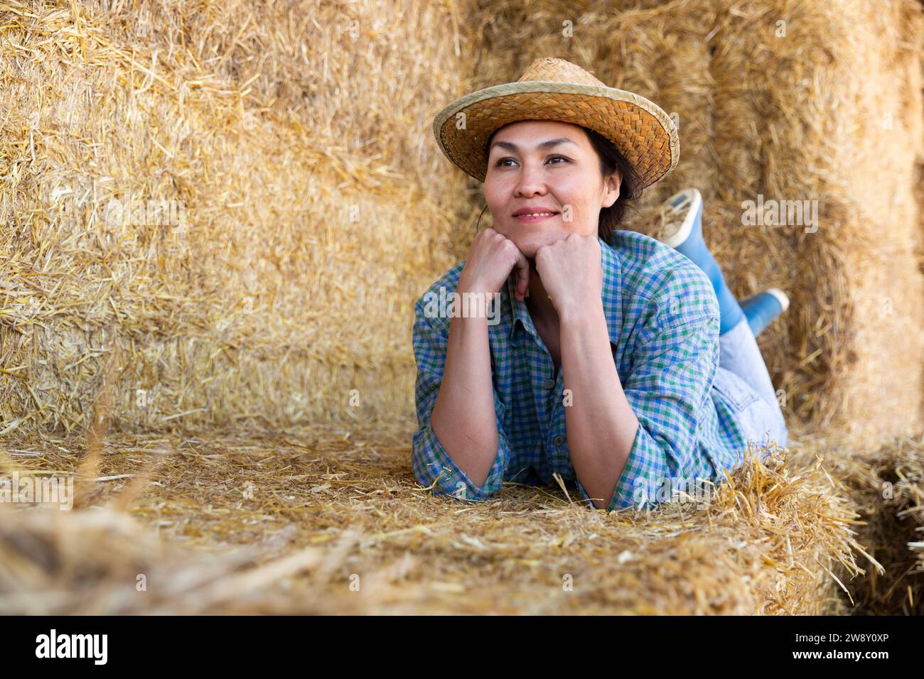 Woman posing at hay storage on farm Stock Photo - Alamy