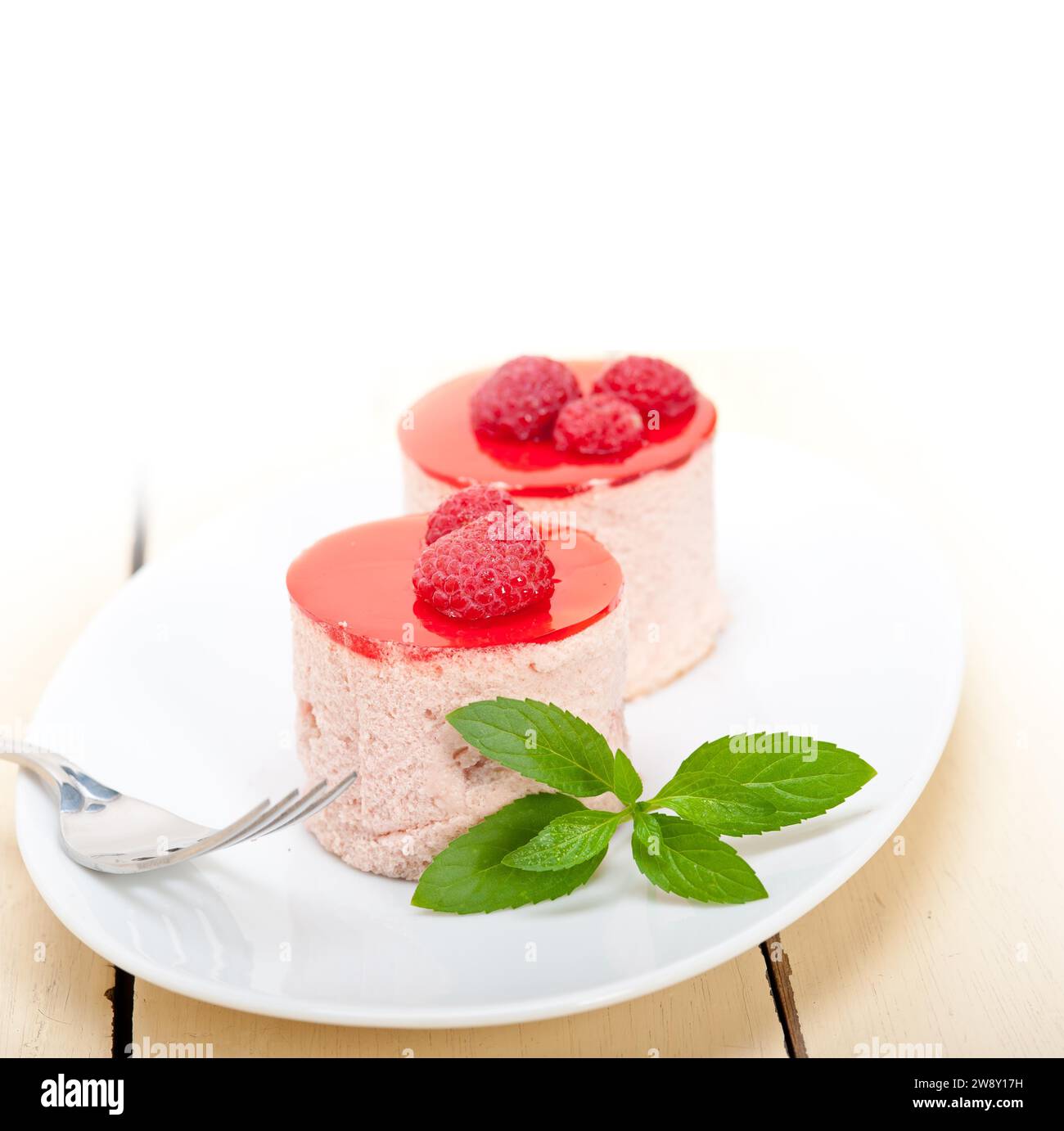 Fresh raspberry cake mousse dessert round shape with mint leaves, food ...