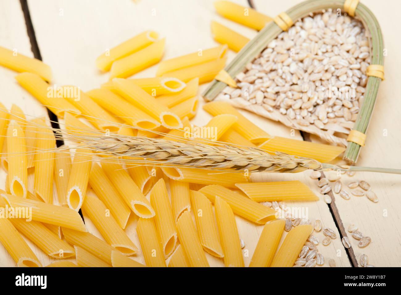 Short Italian pasta penne with durum wheat grains, food photography ...