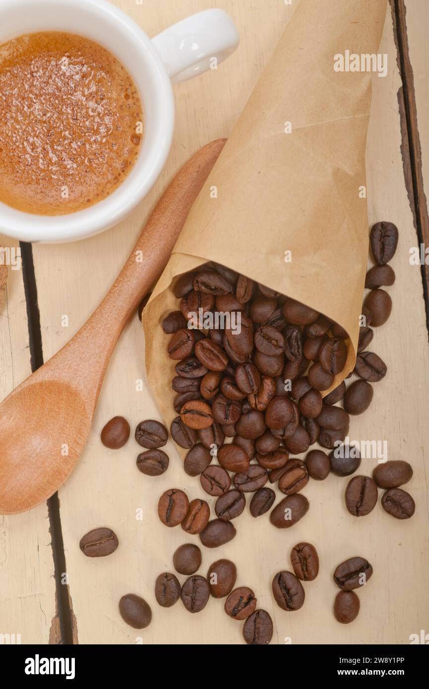 Espresso coffee and beans on a paper cone cornucopia over white ...