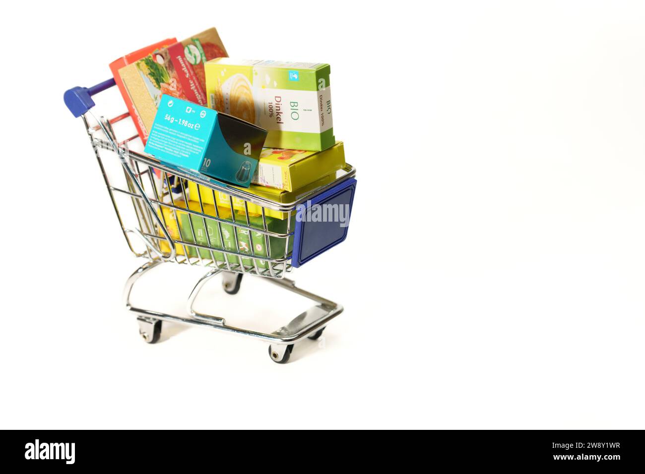 Shopping cart full of boxes of grocery items isolated on a white ...