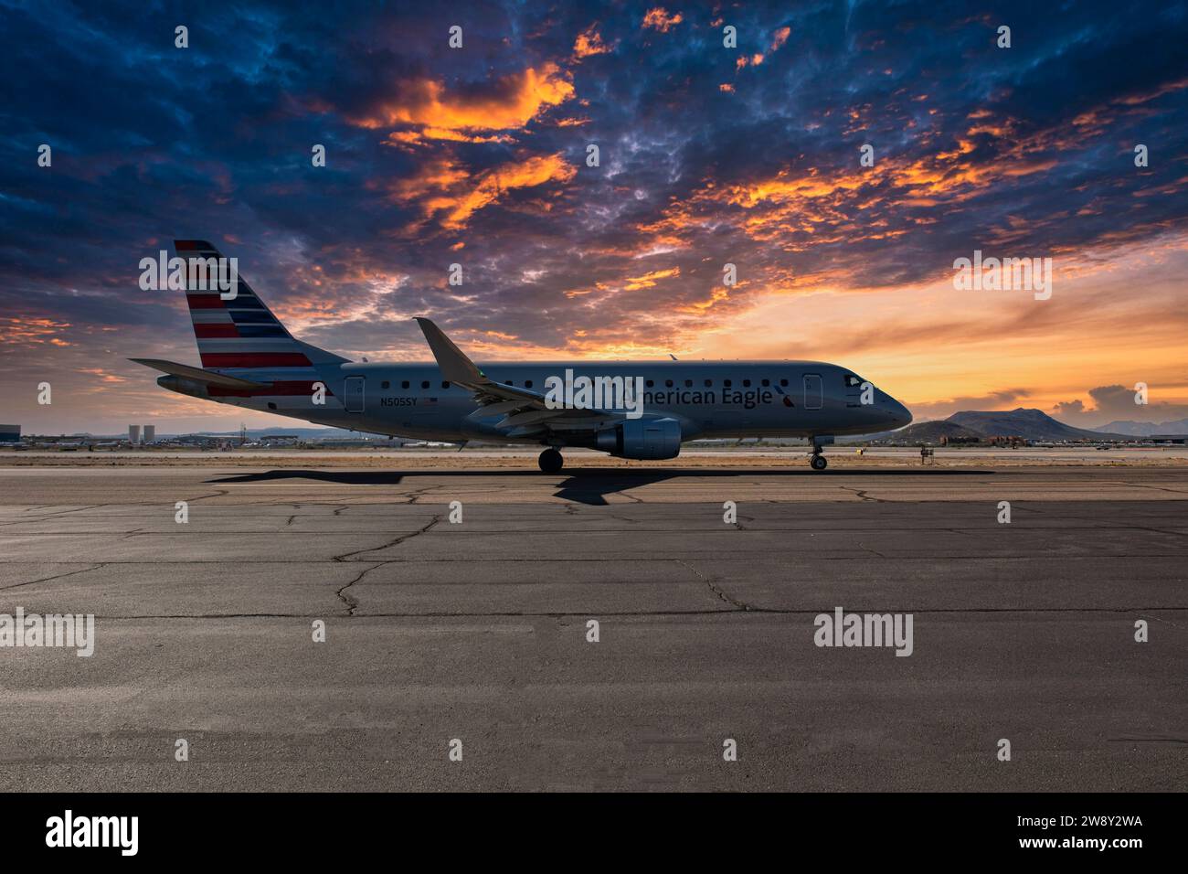 American Airlines Eagle Embraer E175LR taxies to the active runway at ...