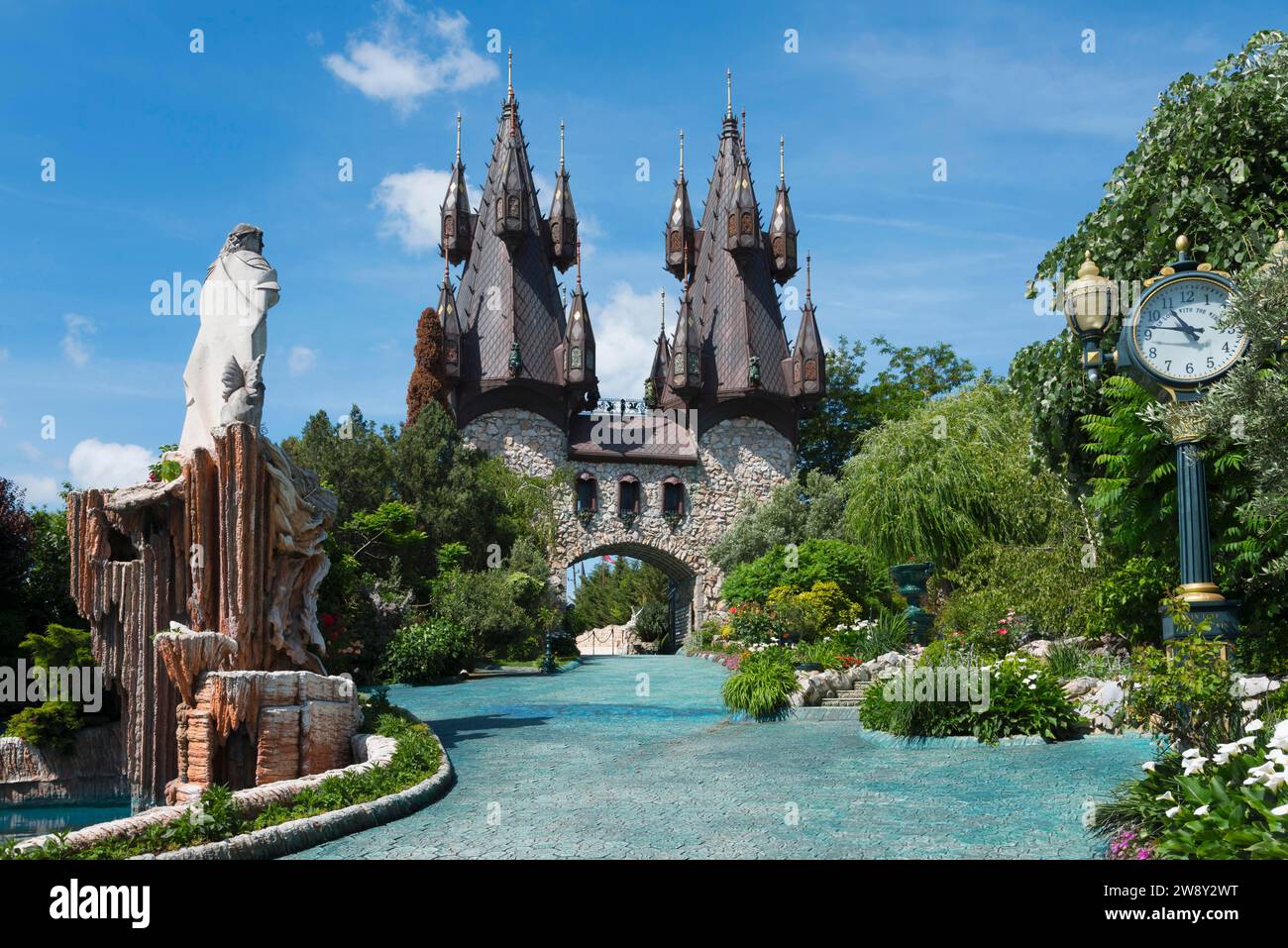 A fairytale castle with pointed towers, fountains and a clock ...